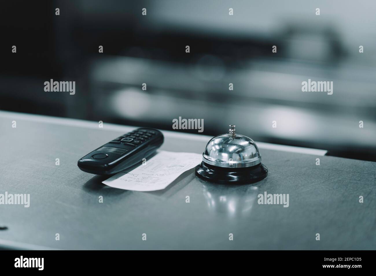 Wireless phone, kitchen ticket and order bell on stainless steel bench ...