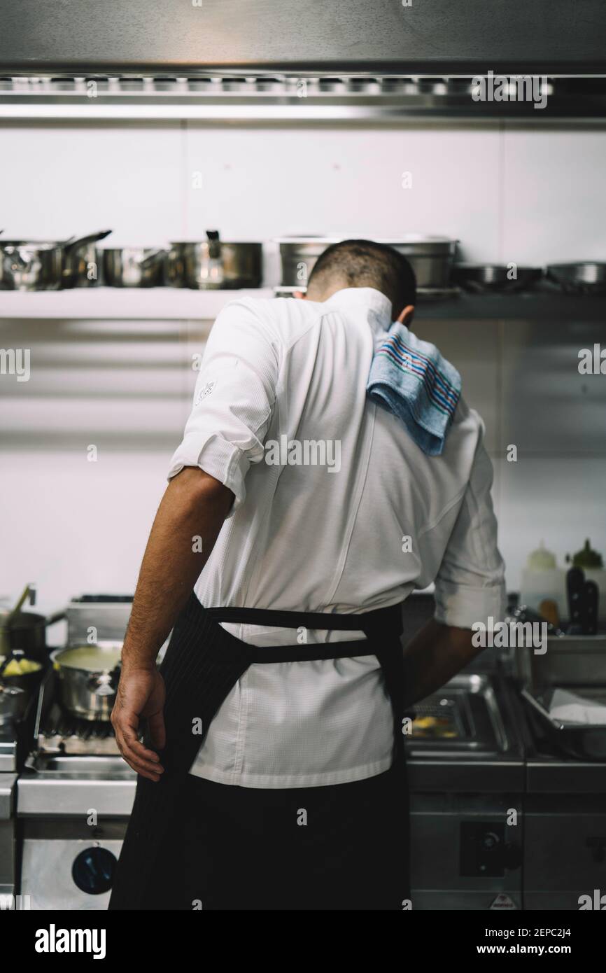 Portrait of a male chef backwards cooking in a restaurant kitchen Stock ...