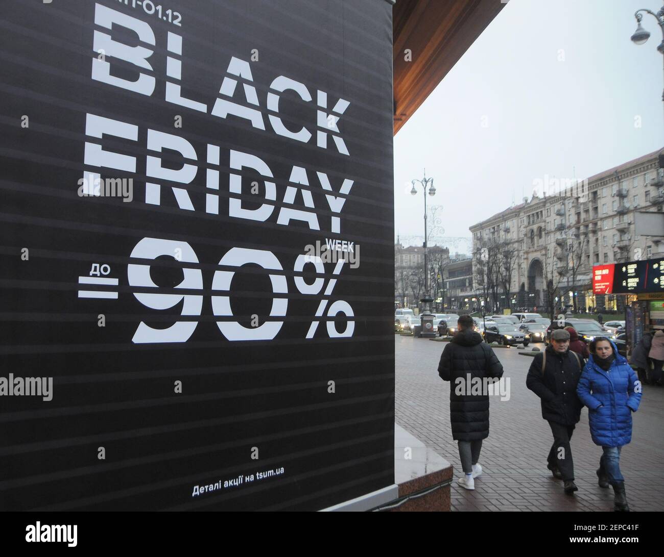 shoppers walk past the Black Friday sales board in Kiev. (Photo by ...