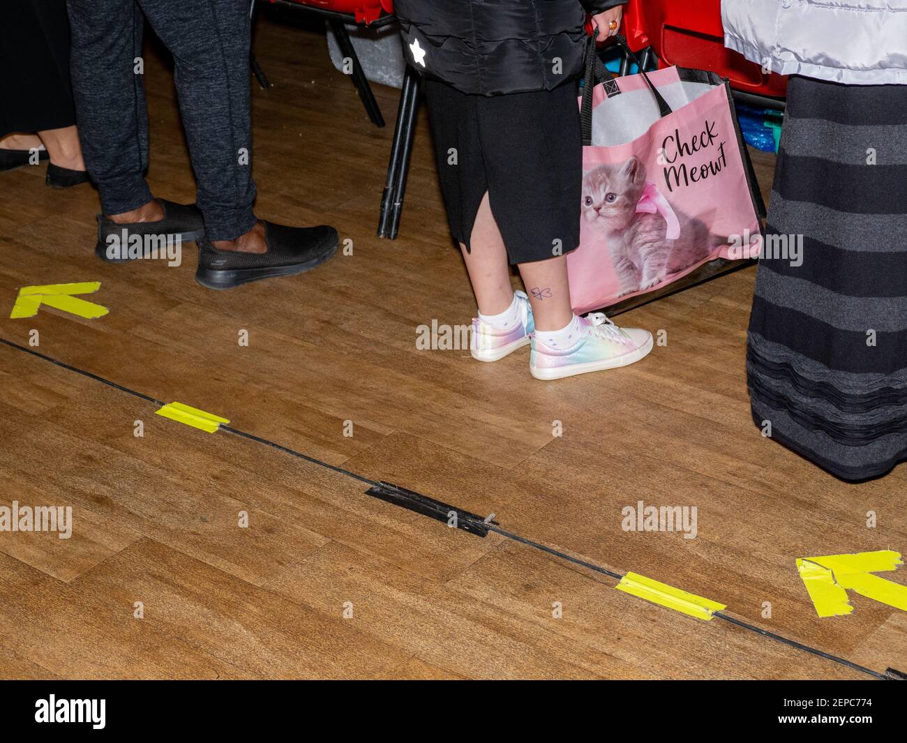 Beneficiaries queue for food at a food bank in London, England Stock ...