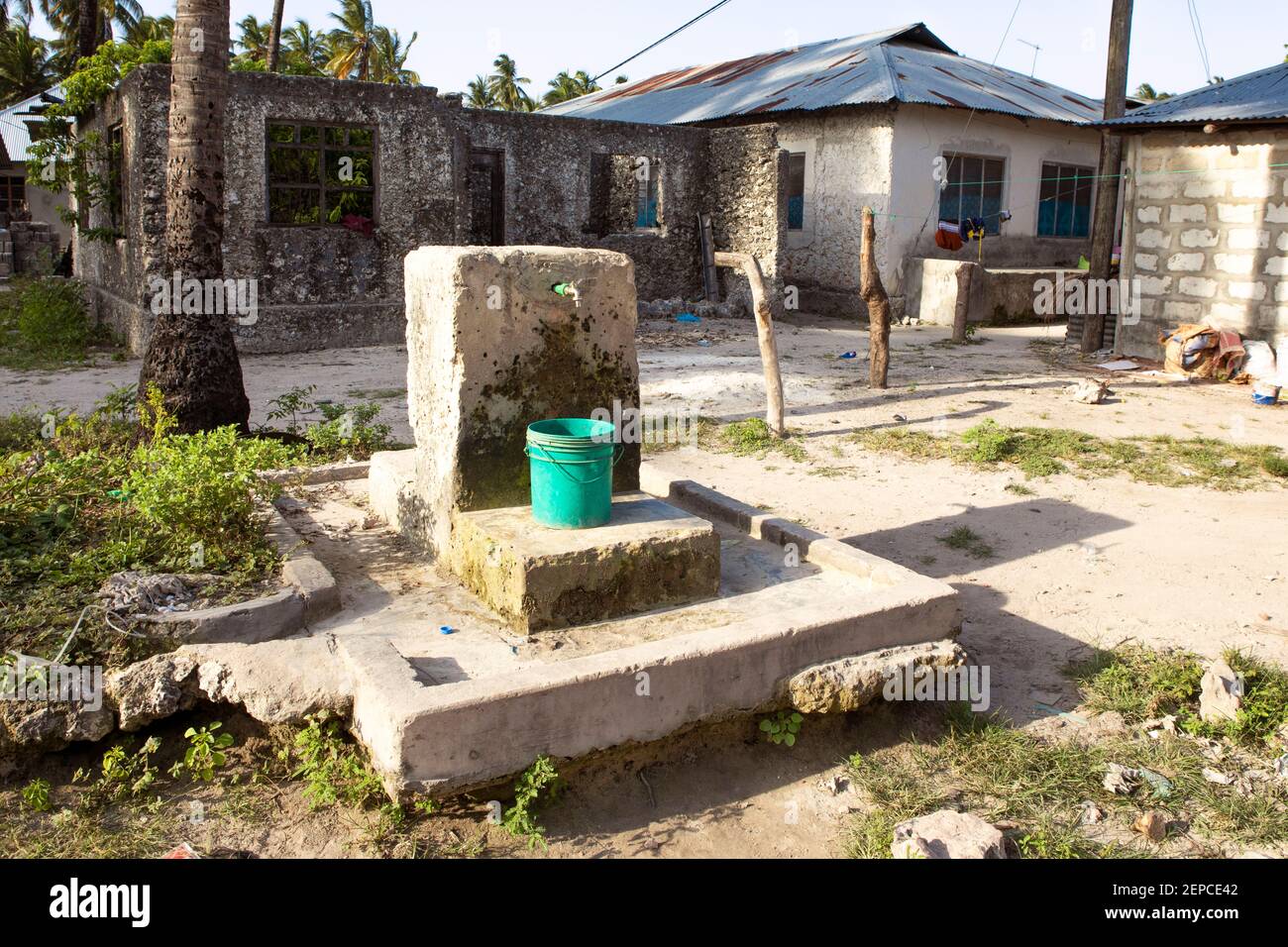 Drinking water supply, well in african village. Plastic container under ...
