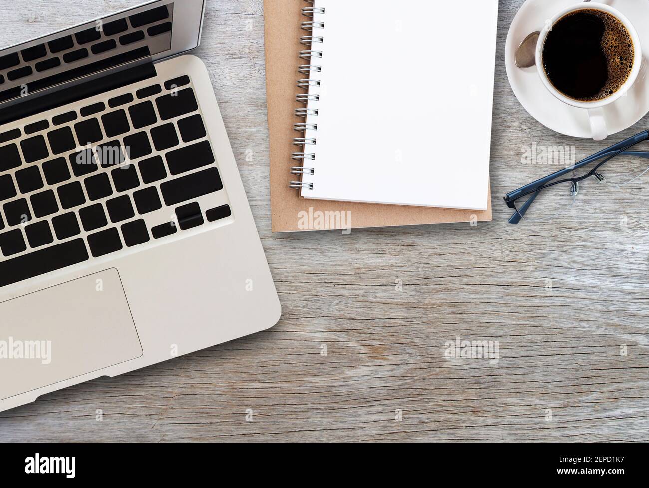 flat lay top view of laptop computer,cup of coffee and notepad on ...