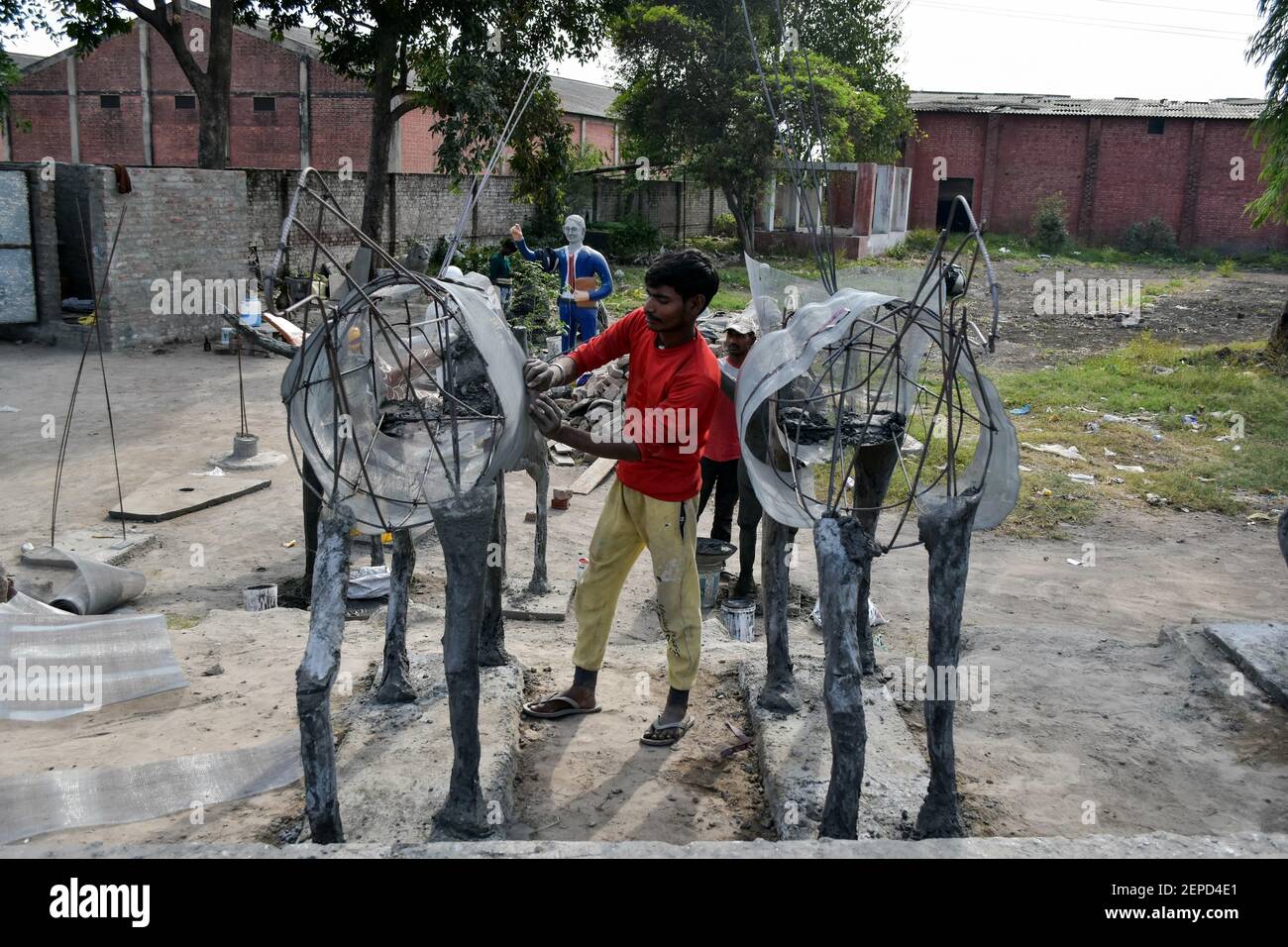 An Indian artist works on a sculpture on the outskirts of Patiala ...