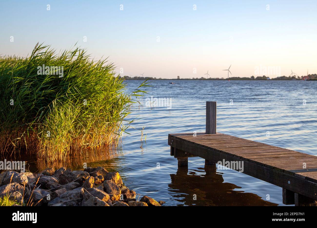 Beautiful tranquil waterscape in warm sunset light in Friesland, The ...