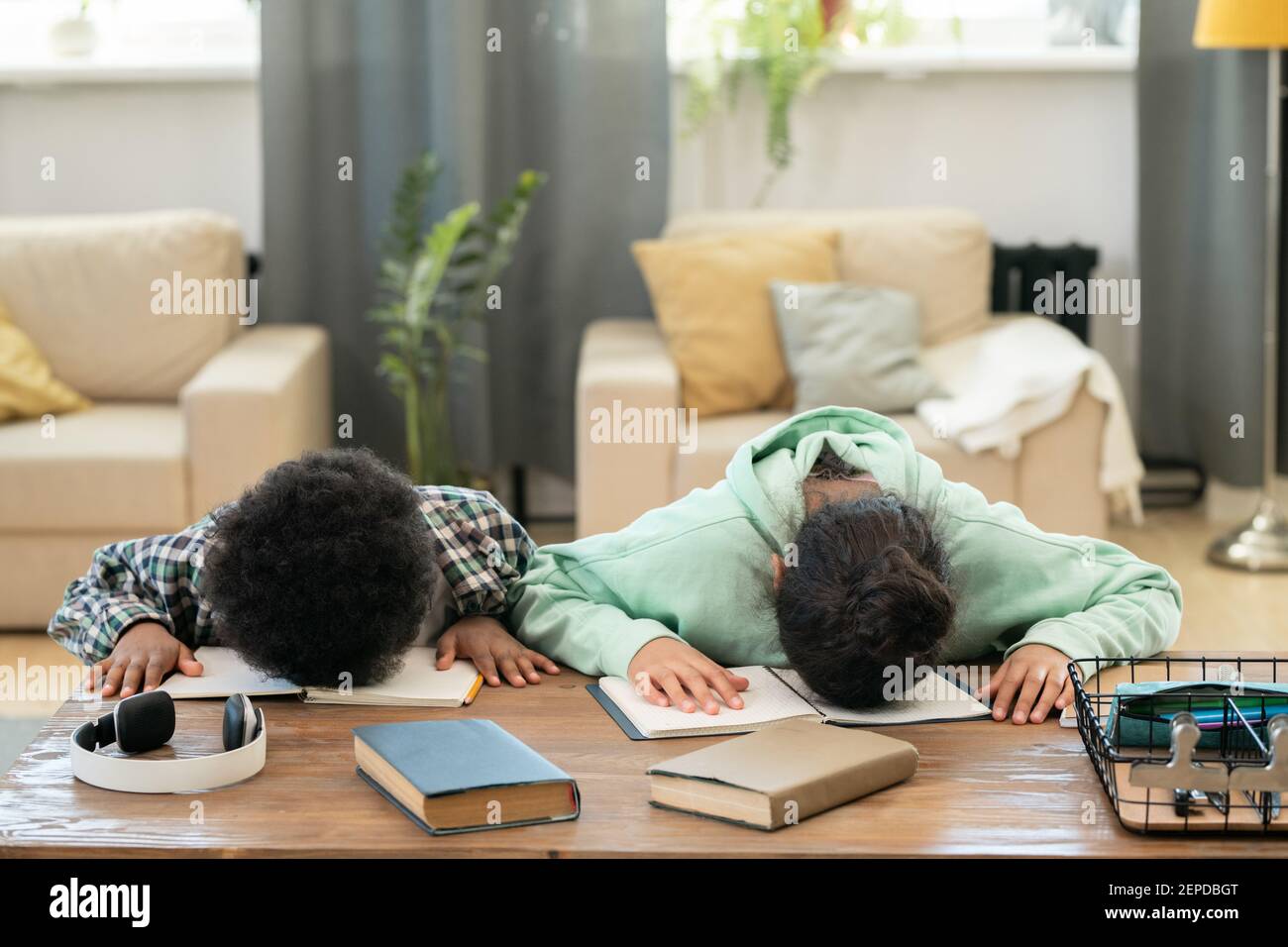 Tired elementary schoolchildren in casualwear lying on their open ...
