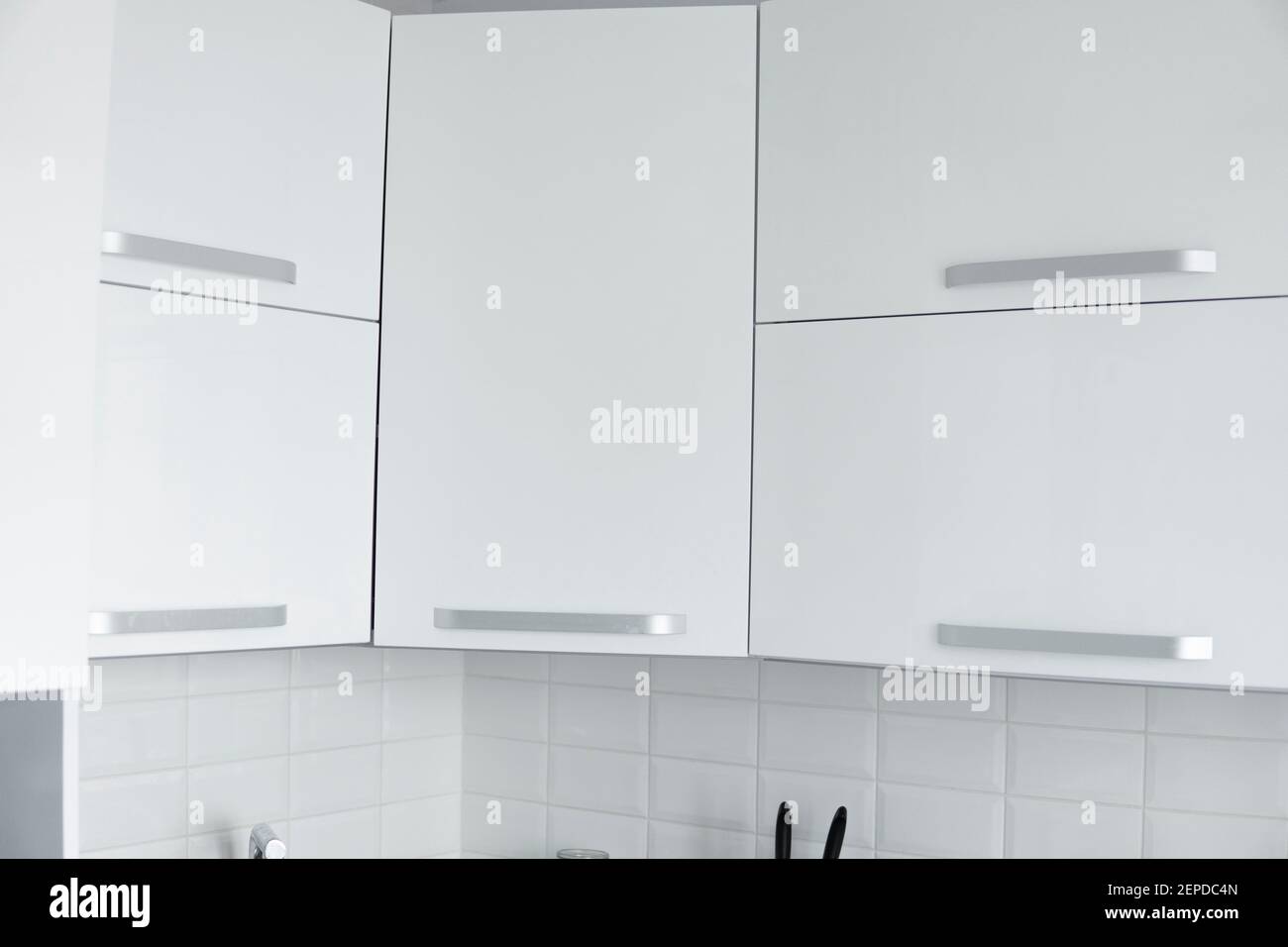 White lacquered kitchen facades on a comfortable kitchen. Modern white ...