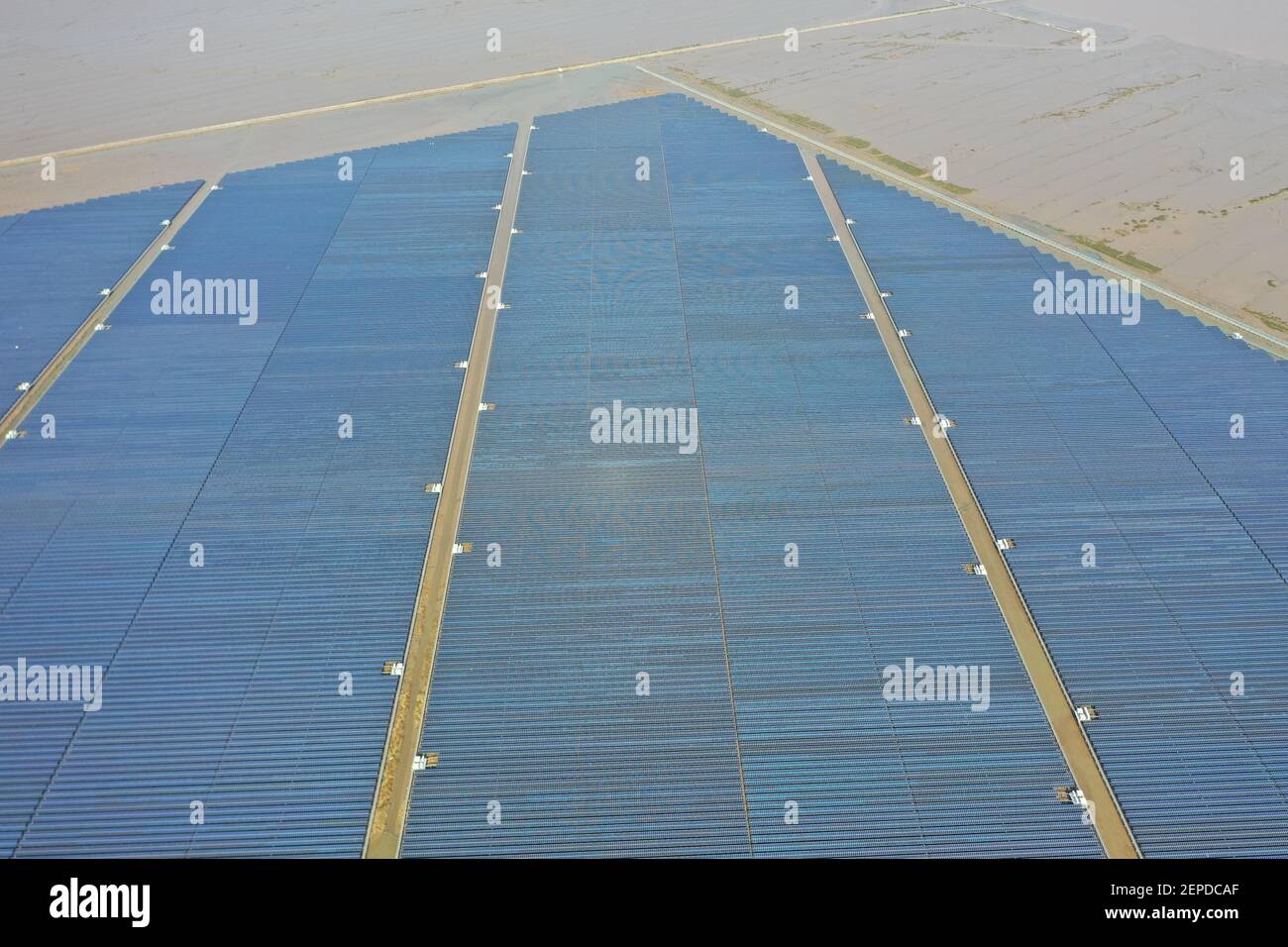 Aerial view of arrays of solar panels at a photovoltaic power station ...
