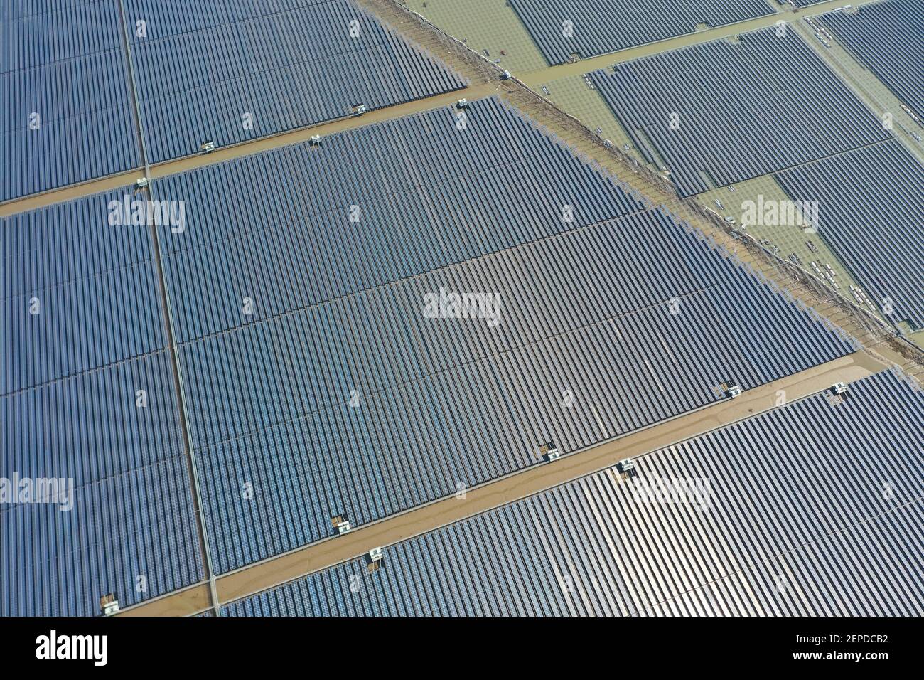 Aerial view of arrays of solar panels at a photovoltaic power station ...