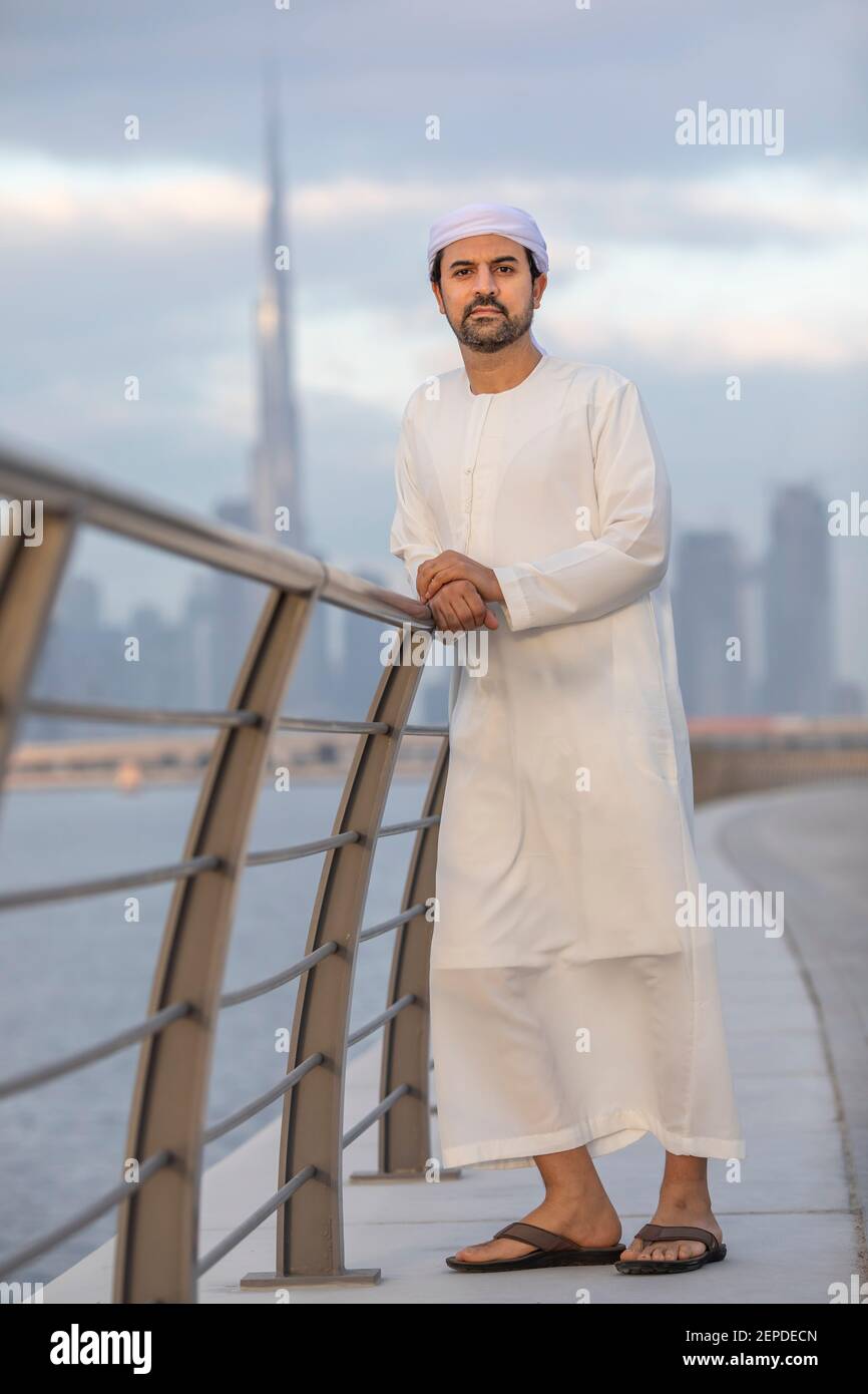 emirati Man at Al Jaddaf waterfront in Dubai with Burj Khalifa at the ...