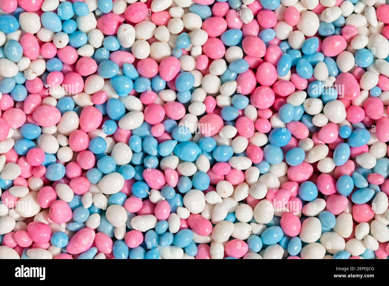 Close up of blue, pink and white glazed anise seeds, called "muisjes ...