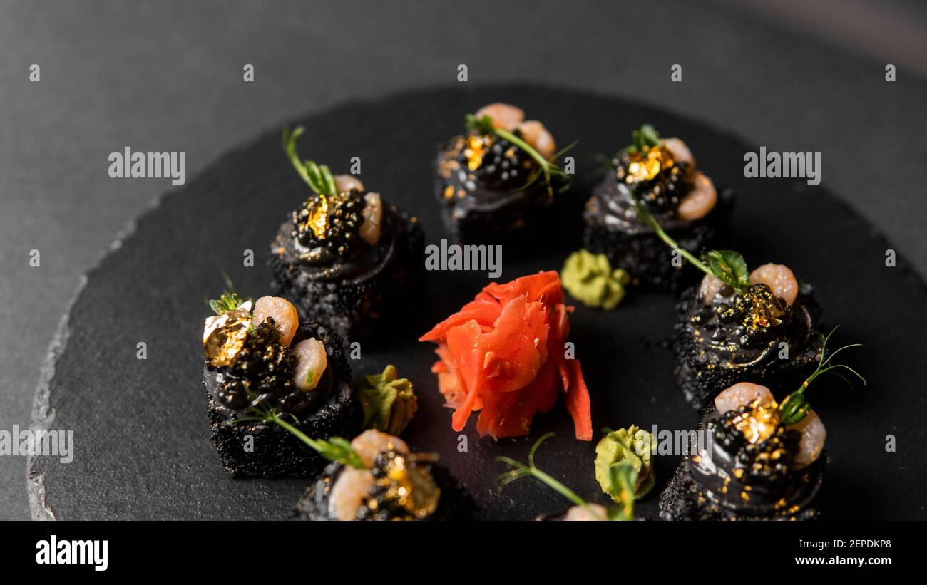 Sushi roll with nori, black rice, crab meat, cucumber, avocado, smoked ...