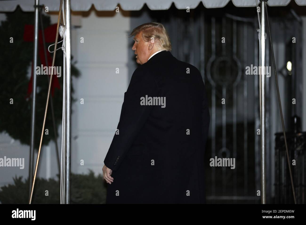 U.S. President Donald Trump enters the White House upon his return to ...