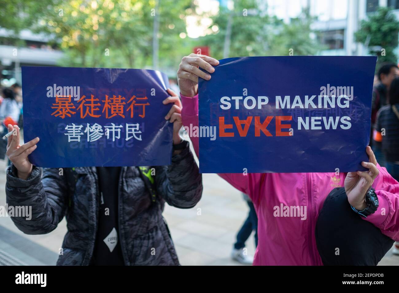 Placards in both Chinese and English saying, stop making fake news ...