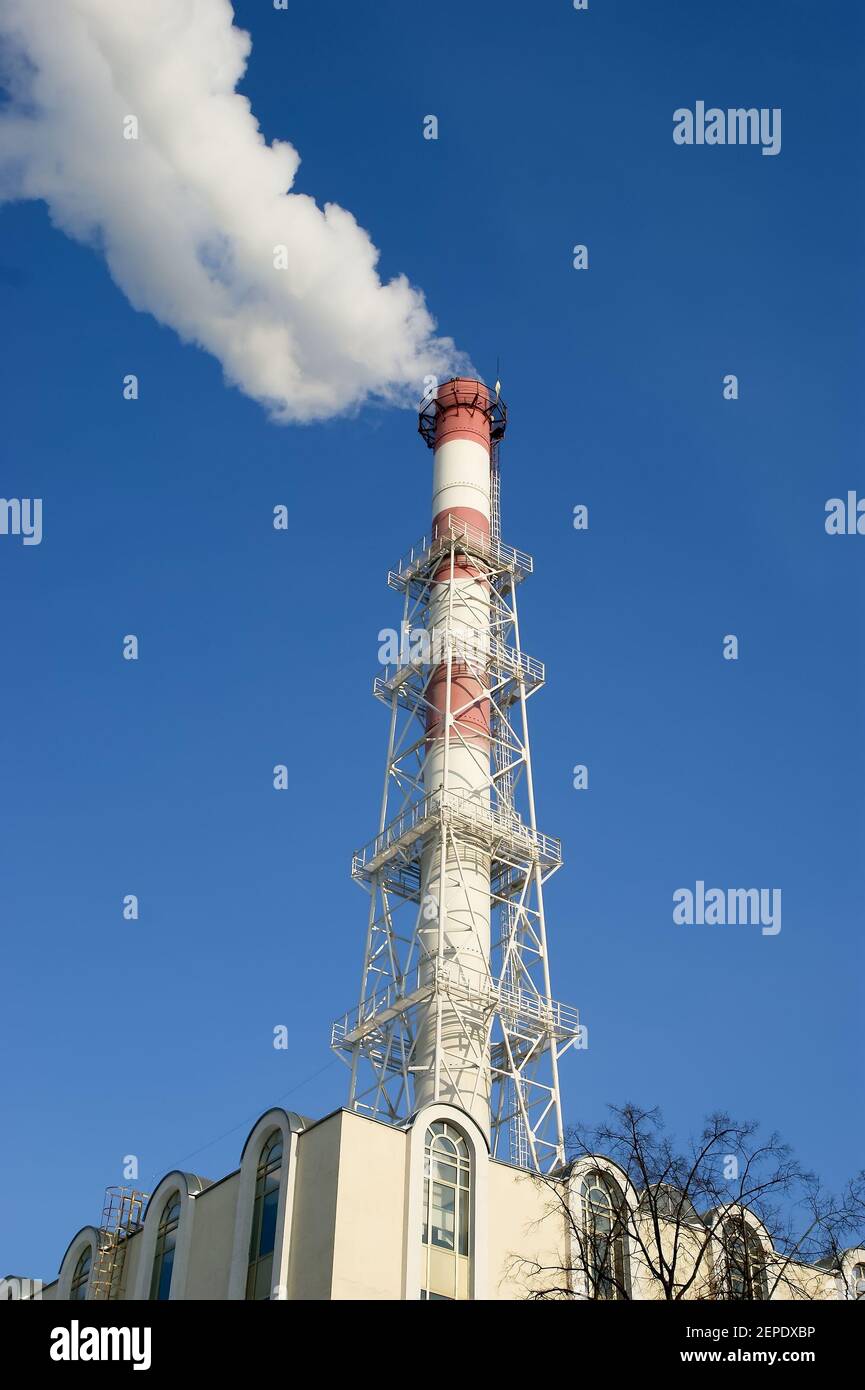Industrial smokestacks with billowing white smoke being pumped into the ...