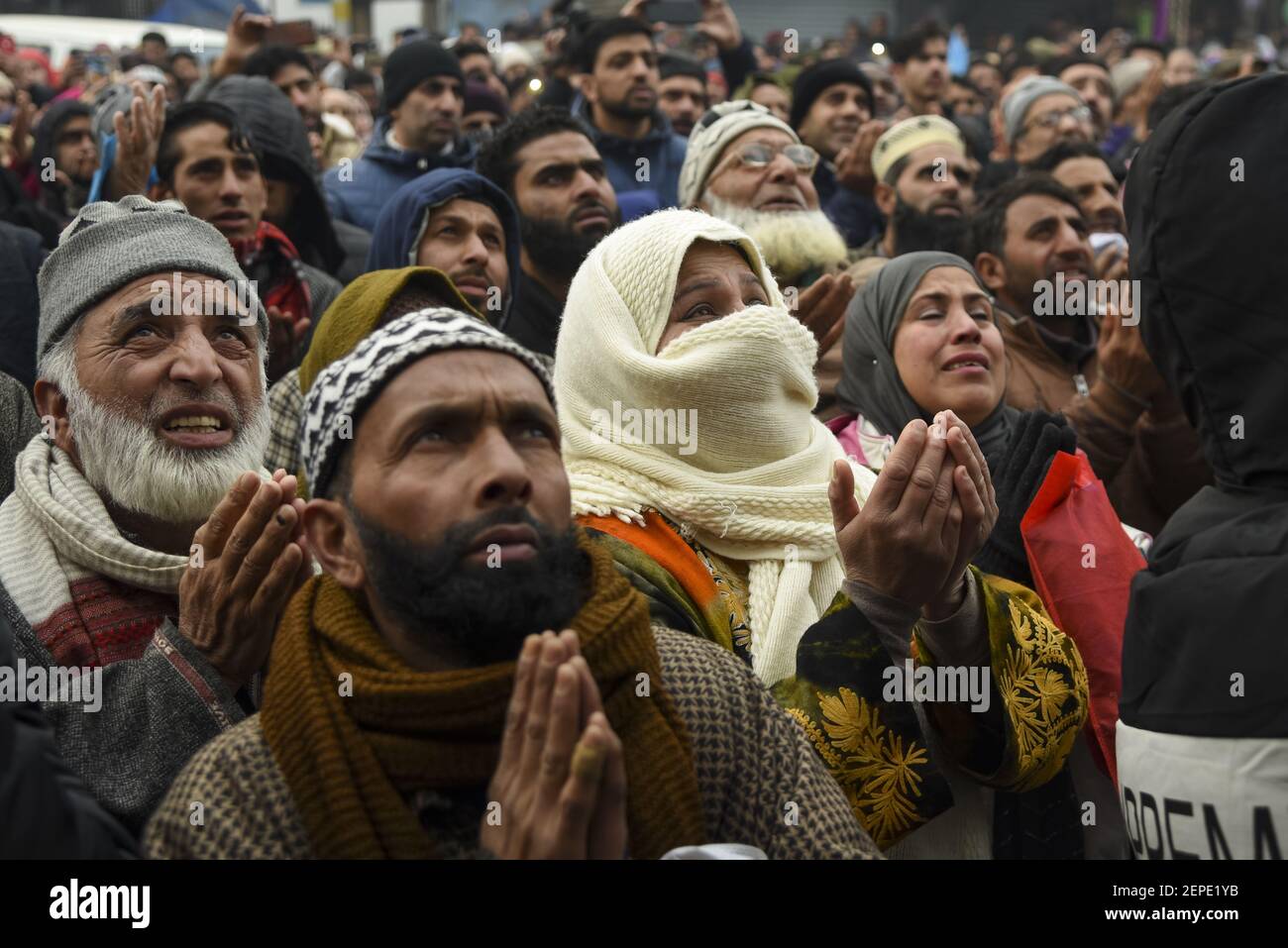 Kashmiri people praying as the head Priest displays the holy relic of ...