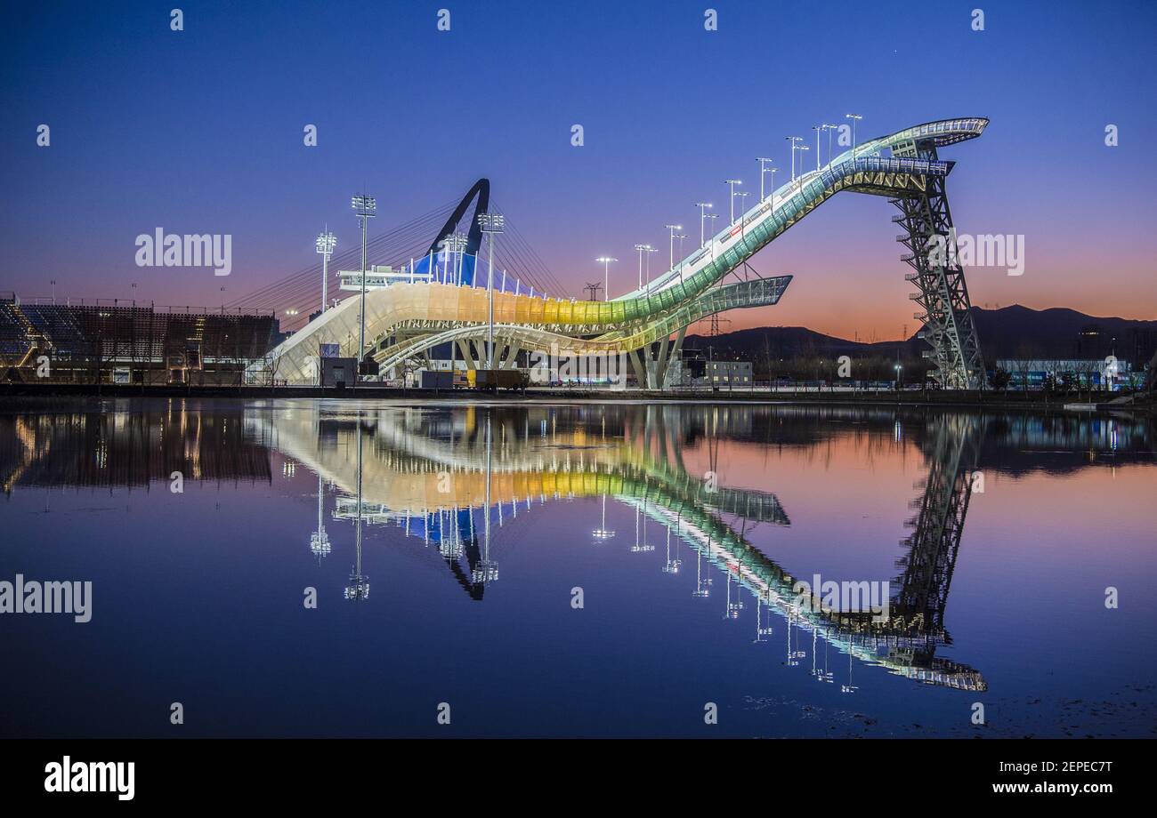 The Shougang Ski Jumping Platform turn on light at night, resembling a ...