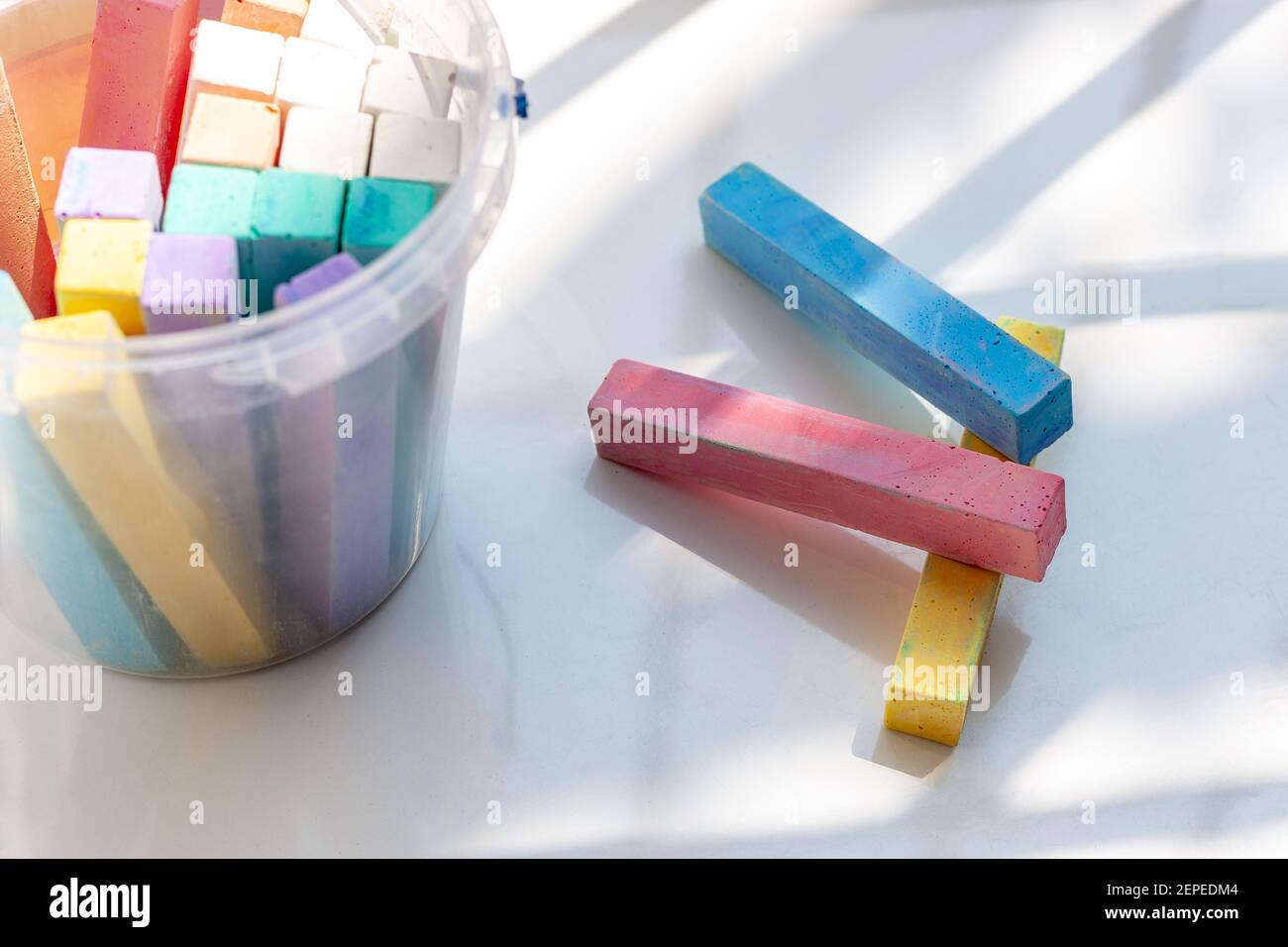 color chalk at plastic container on the light background. back to ...