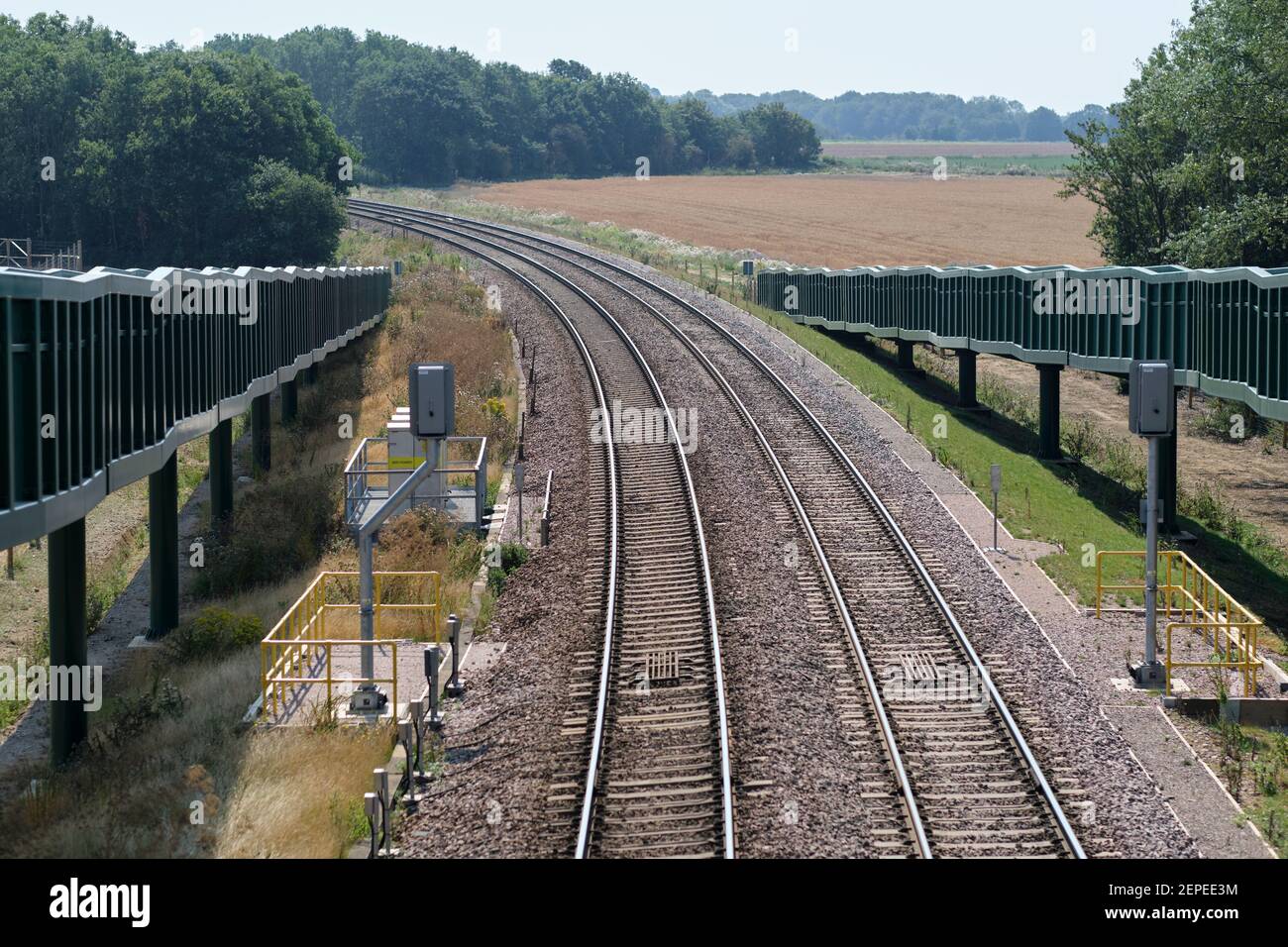 Double rail tracks curving left with ramps for horse to cross the line ...