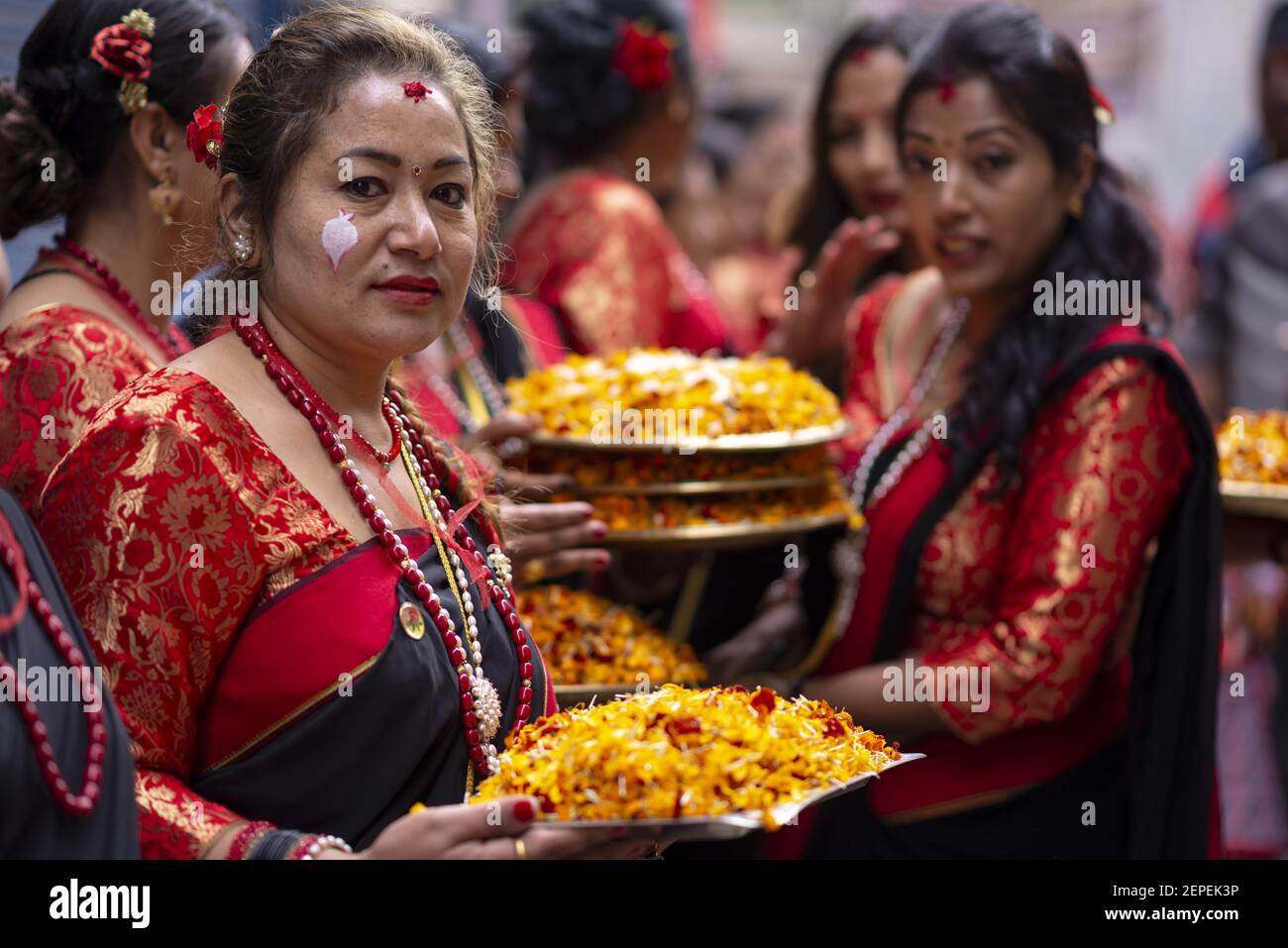 Women from newar community dressed in traditional attires look on while ...