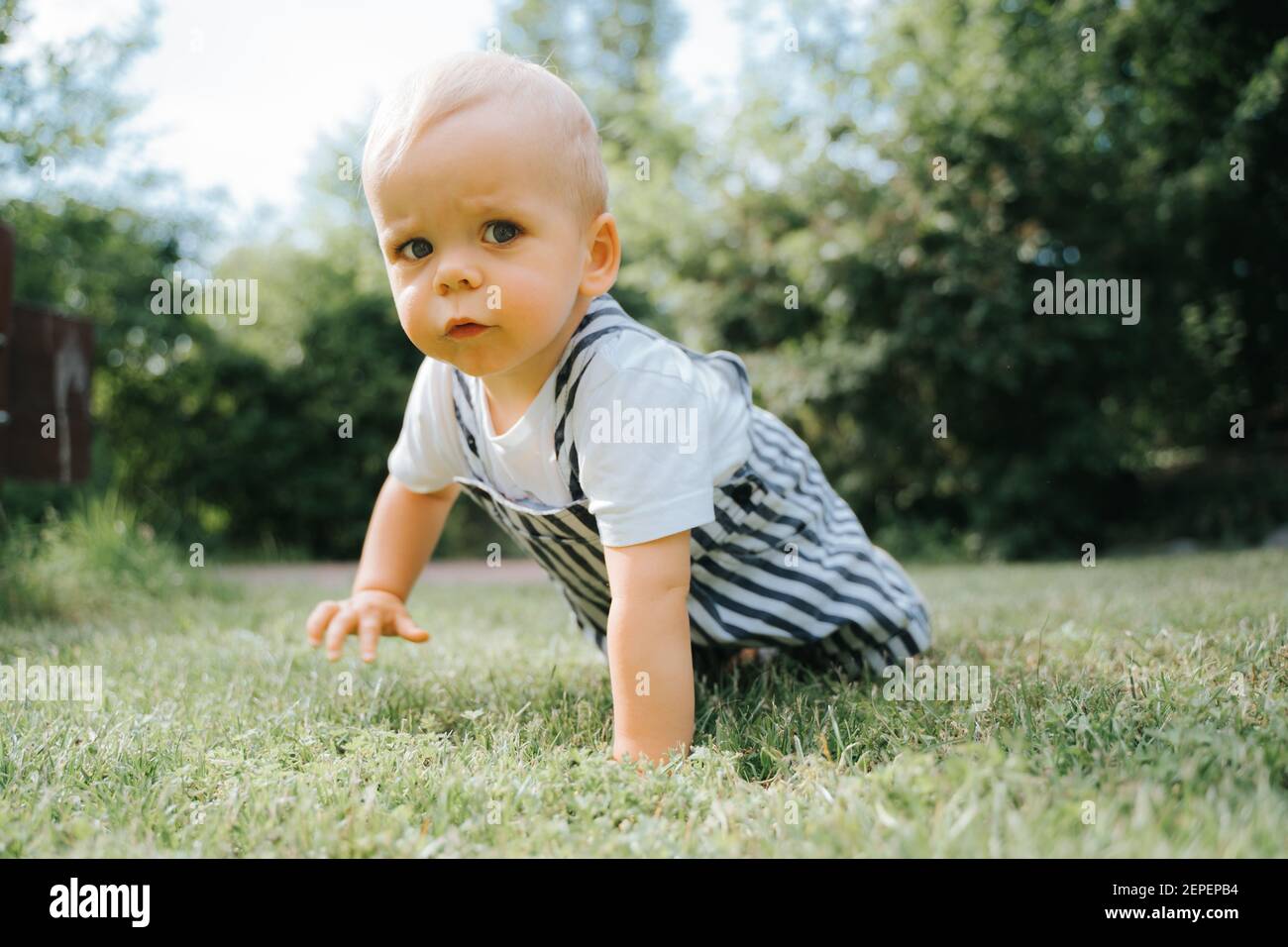 Child crawling on grass hi-res stock photography and images - Alamy