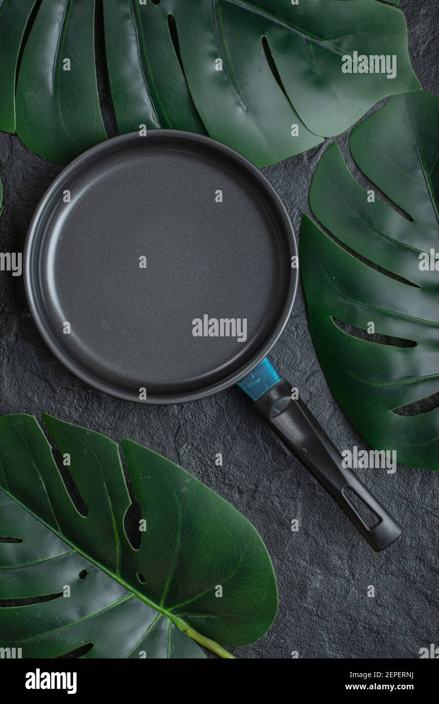 Vertical photo of black frying pan over black background Stock Photo ...