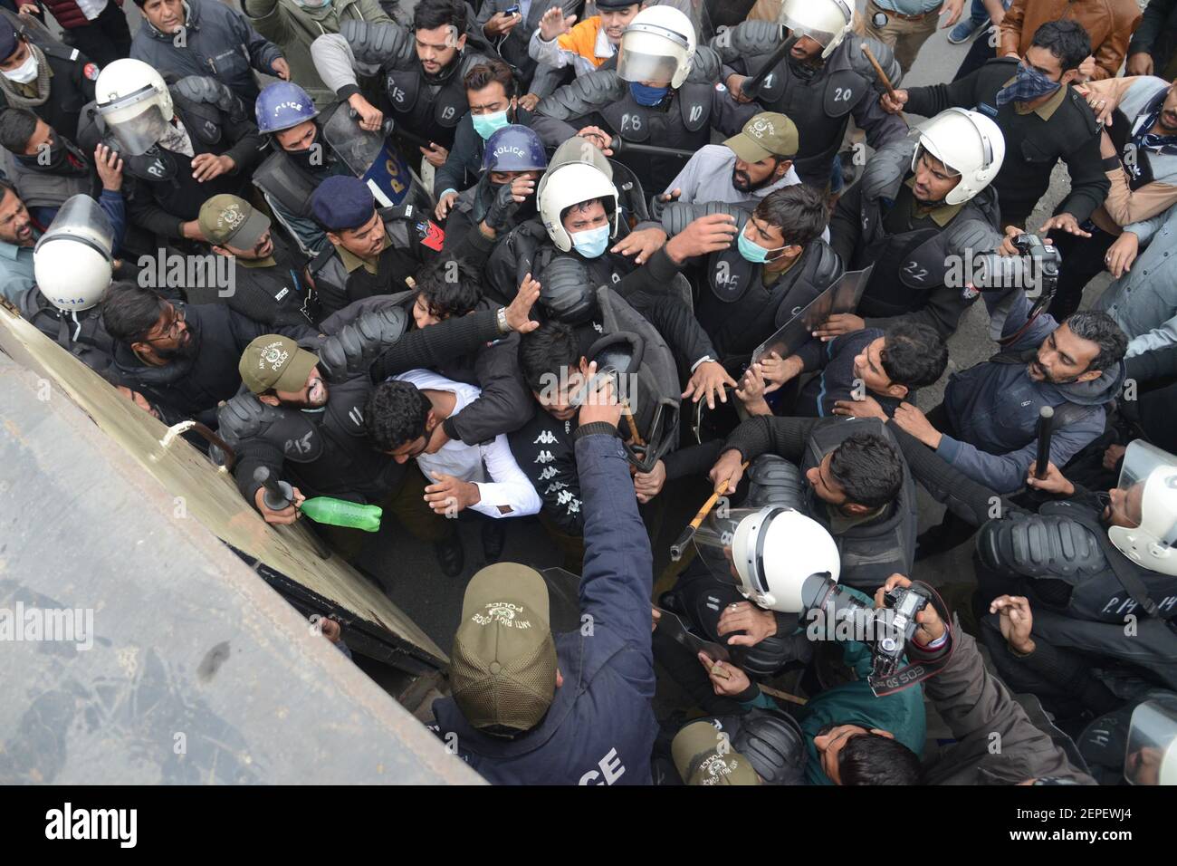 Pakistani Police officers detain angry lawyers (C in white shirt ...