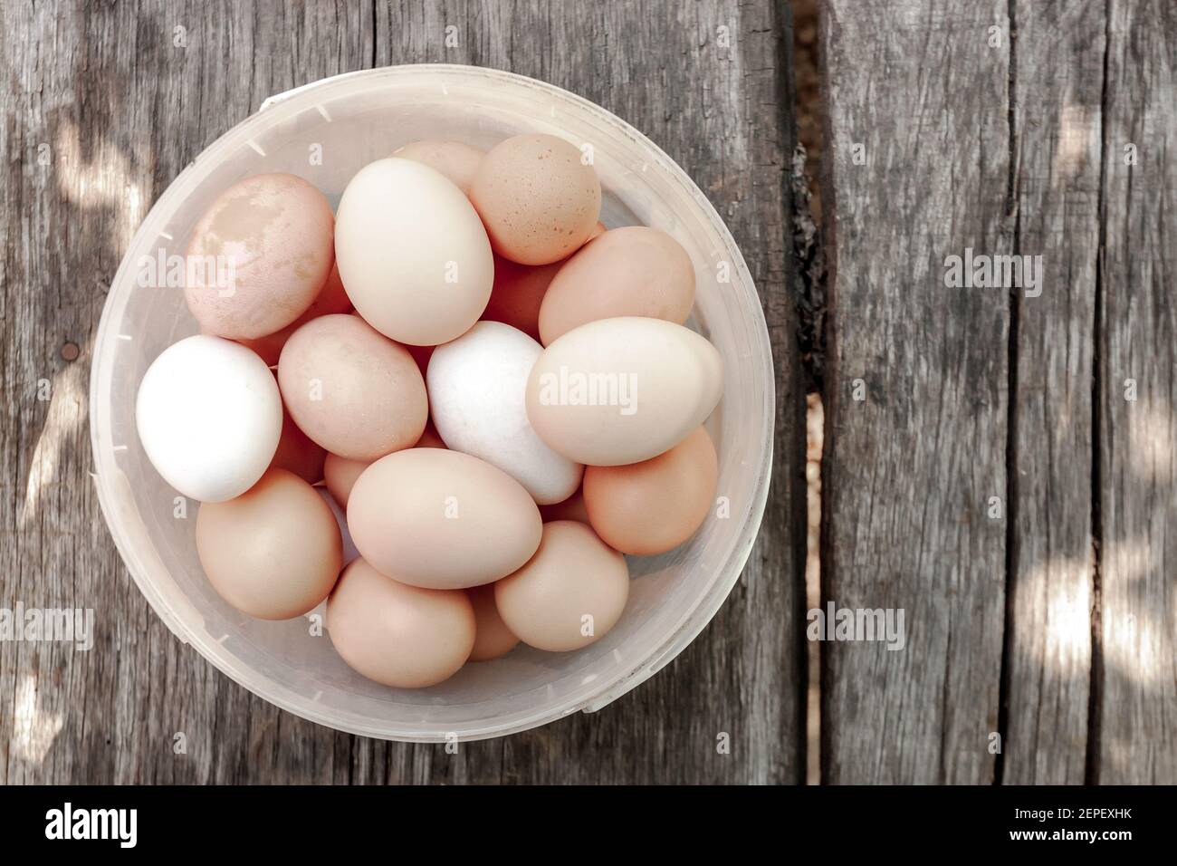 close up bucket with collection of hen eggs. flat lay at wooden ...
