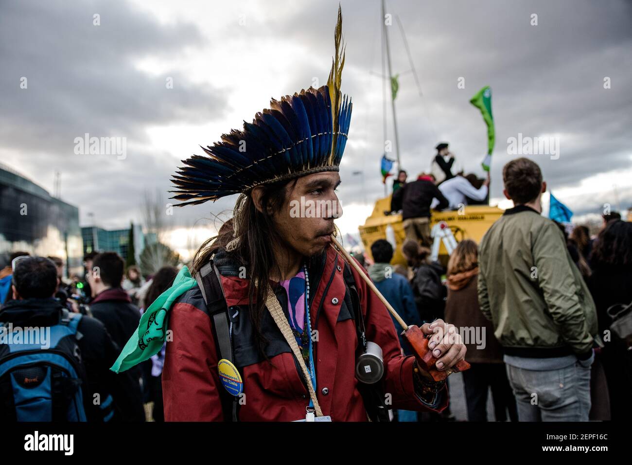 An indigenous activist smokes a pipe during the protest. Hundreds of ...