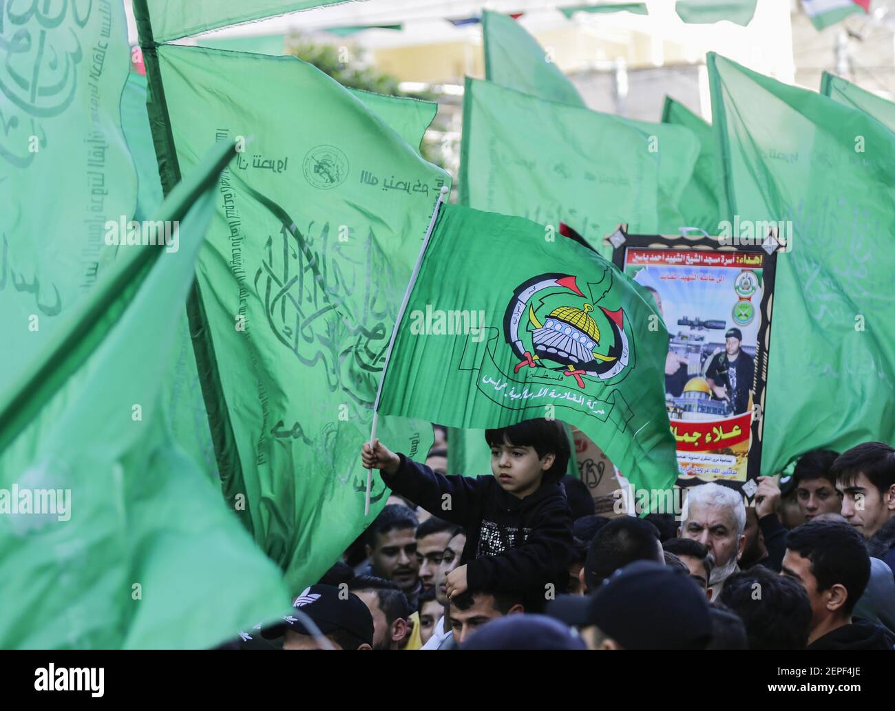 Palestinian Hamas kid supporter waving a flag during a rally marking ...