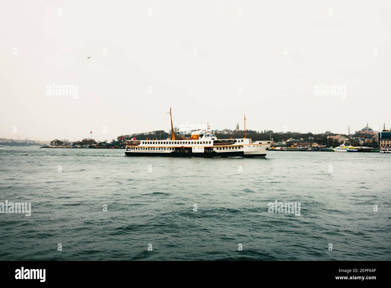Ferry and Istanbul from Galata Bridge. Istanbul city lines ferry near ...