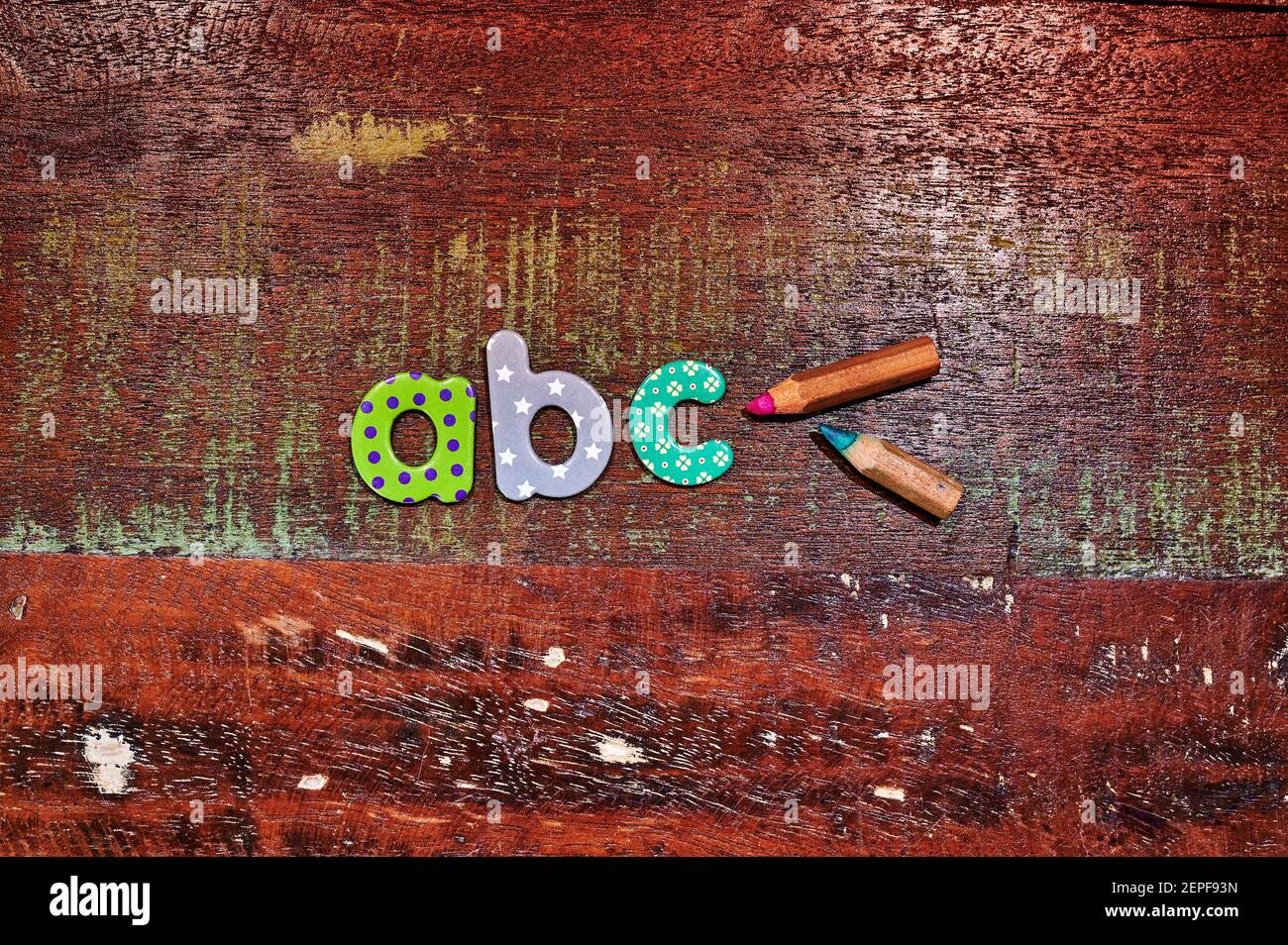 Auburn wooden table with colorful letters that make up the term ABC ...