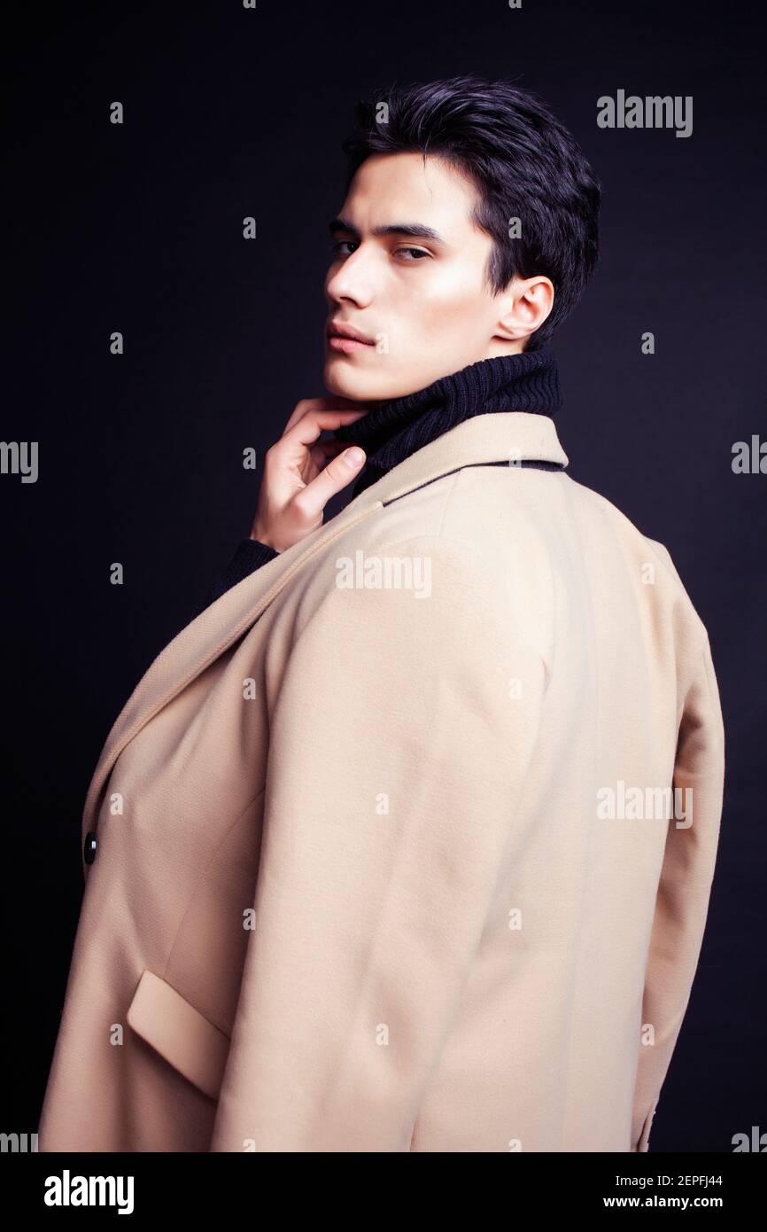 handsome asian fashion looking man posing in studio on black background ...