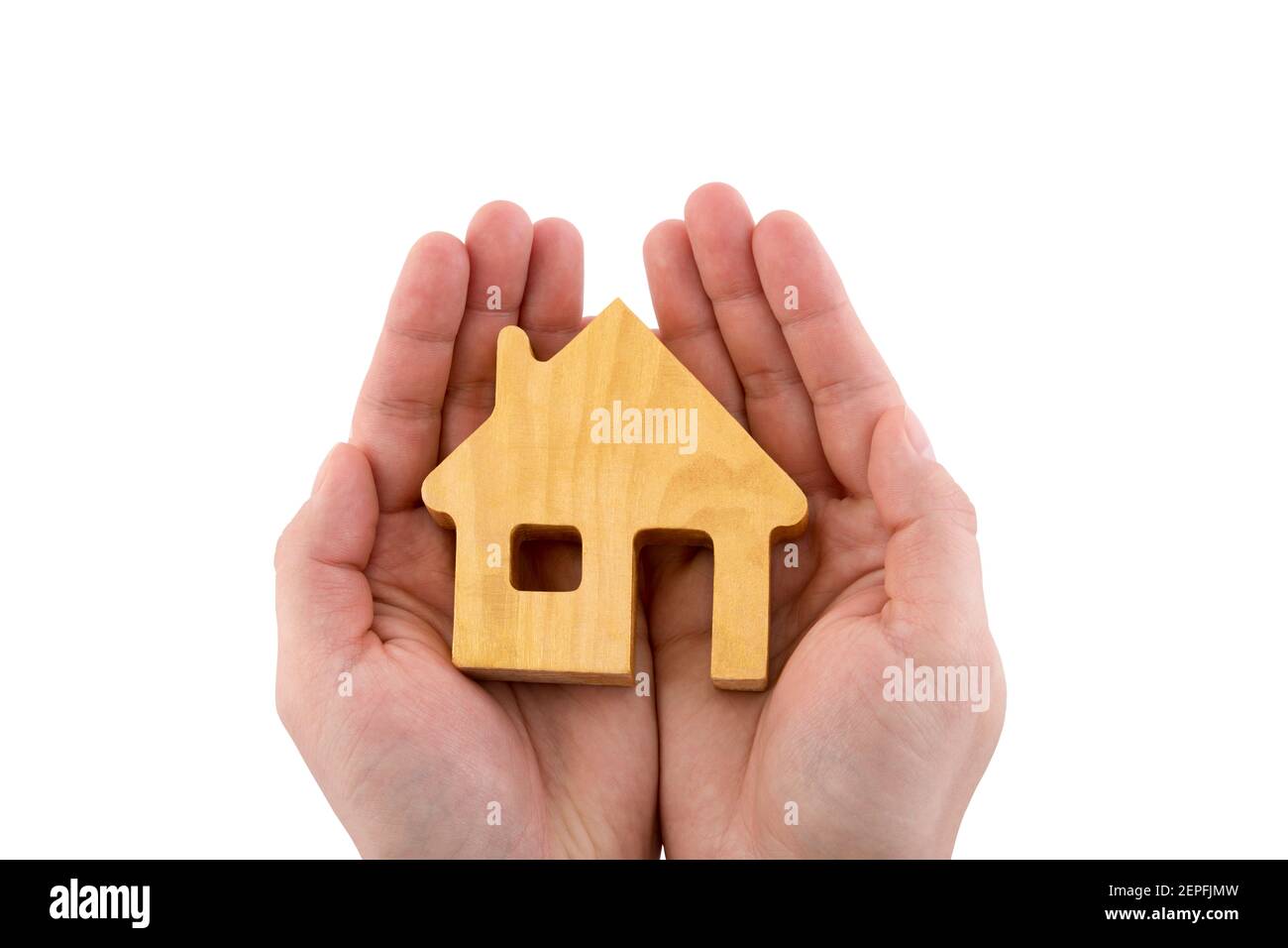Wooden house shape in hands isolated on white with clipping path Stock ...