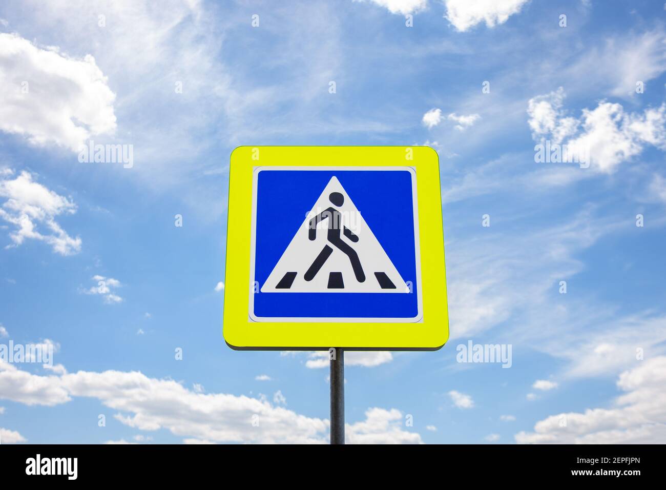 blue pedestrian crossing sign with beautiful white clouds at blue sky ...