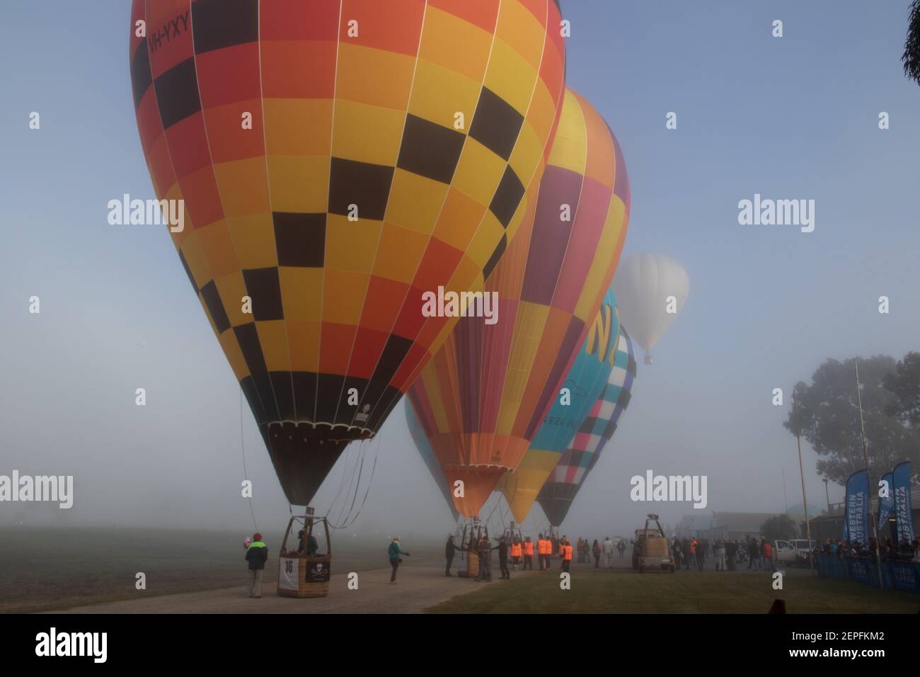 Group of Hot Air Balloons in Mist Preparing for Take Off Stock Photo ...