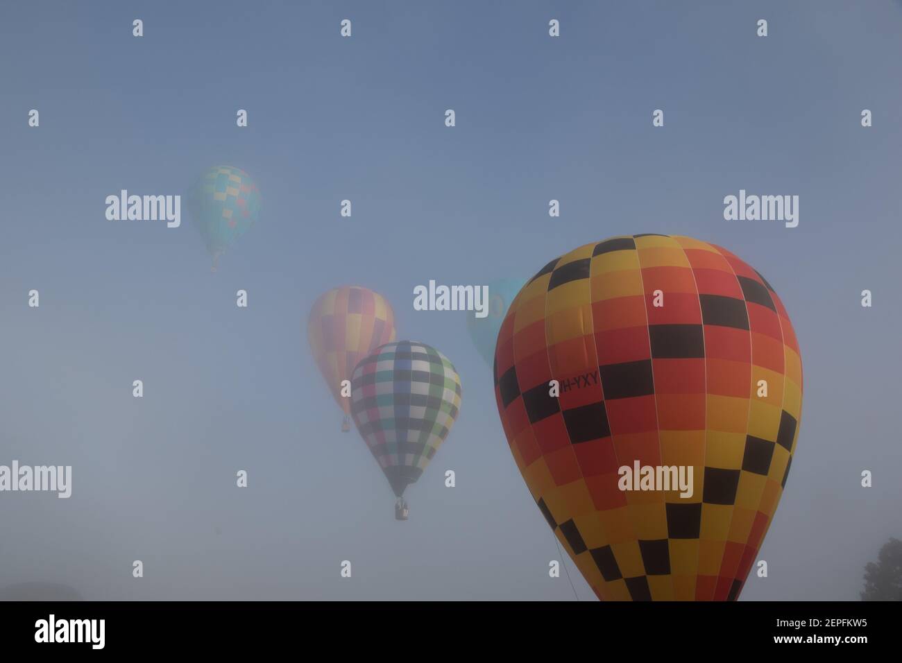 Five Hot Air Balloons In Mist Stock Photo - Alamy