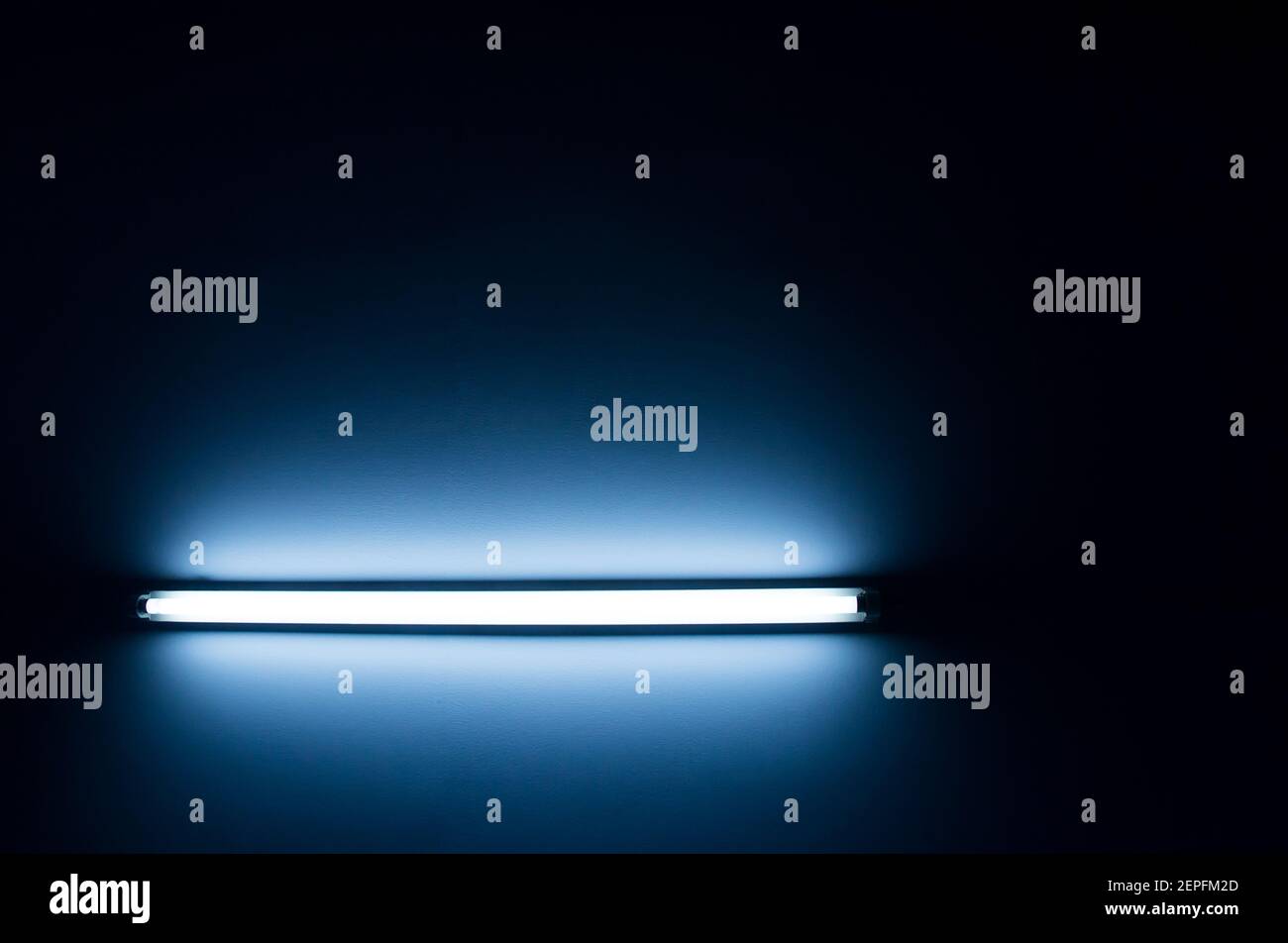 Detail of a fluorescent tube mounted on a wall, false green color light ...