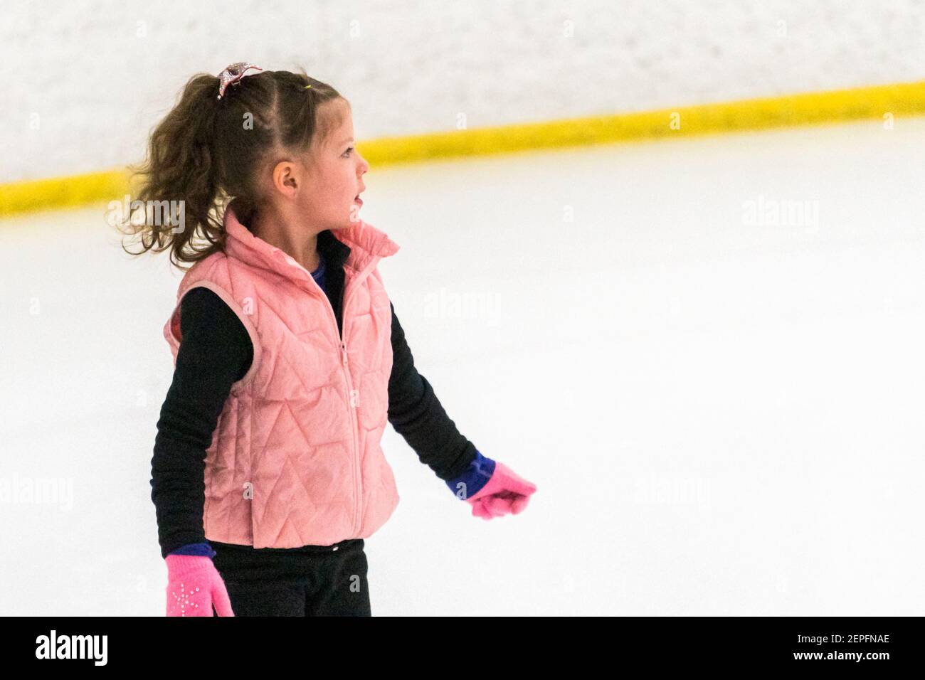 Little skater practicing her elements at the morning figure skating ...