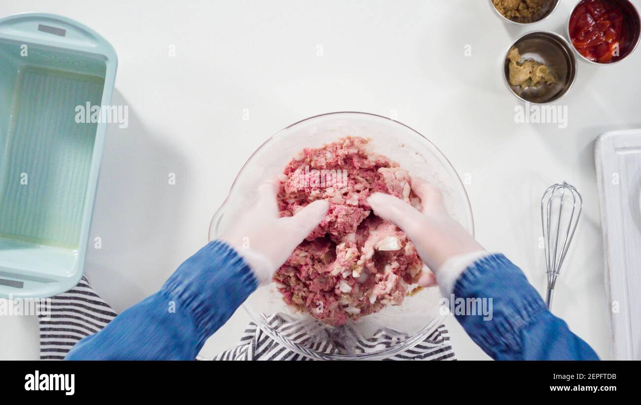 Flat lay. Step by step. Mixing ingredients for a classic beef meatloaf ...