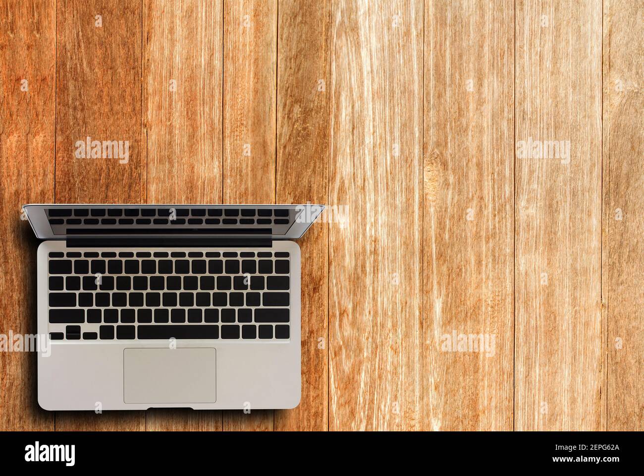Laptop computer on wood table top view with copy space.Office supplies ...