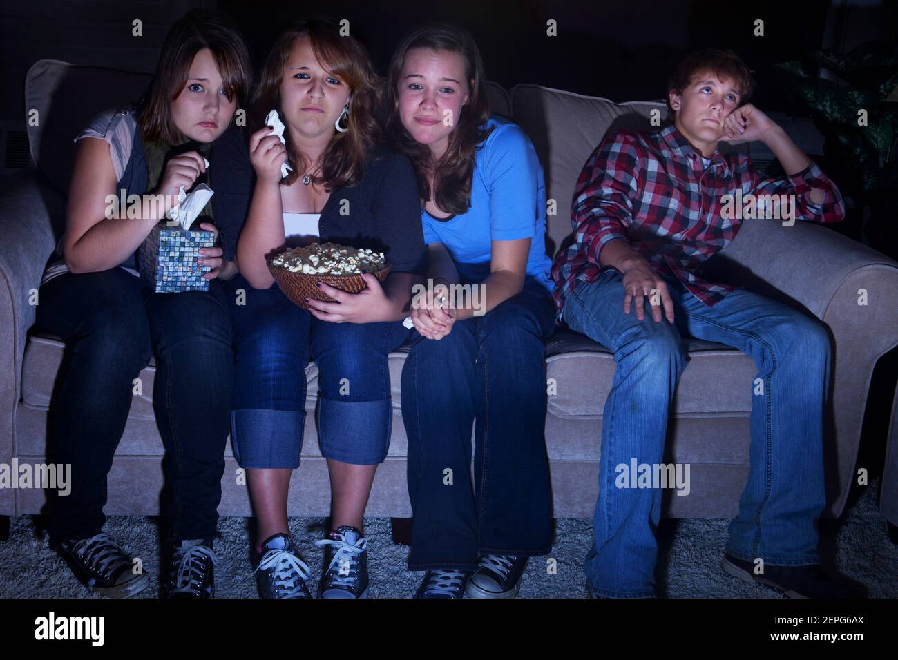 A group of girls crying over a romantic movie while a male friend rolls ...