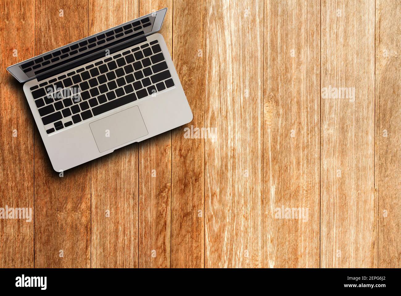 Laptop computer on wood table top view with copy space.Office supplies ...