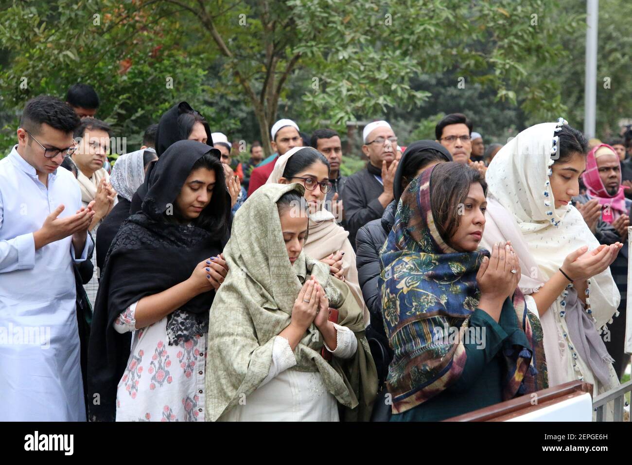 Relatives pray during the ceremony at the Banani Graveyard in Dhaka ...