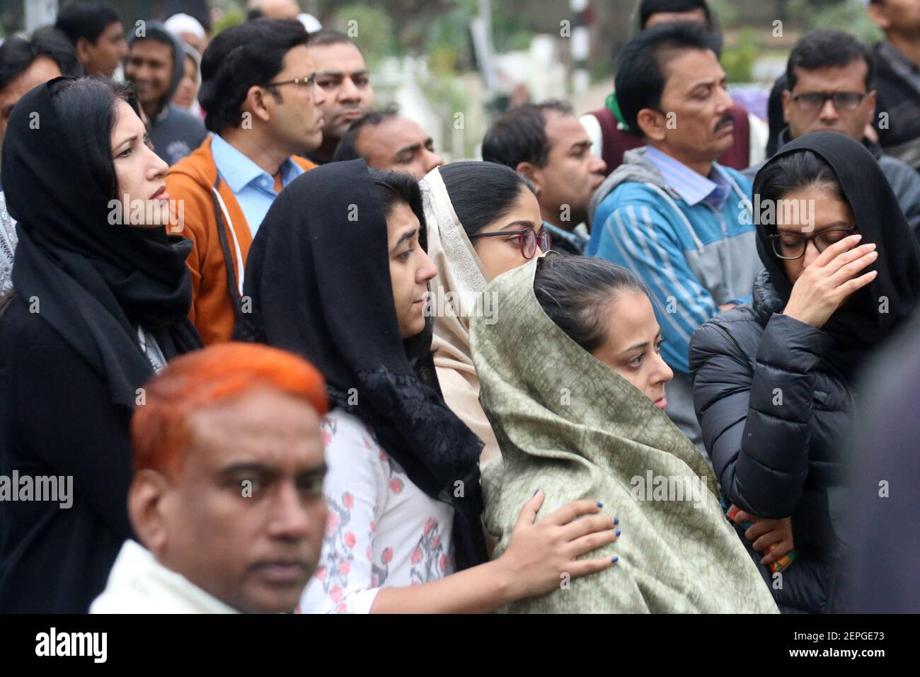 Relatives attend the ceremony at the Banani Graveyard in Dhaka ...
