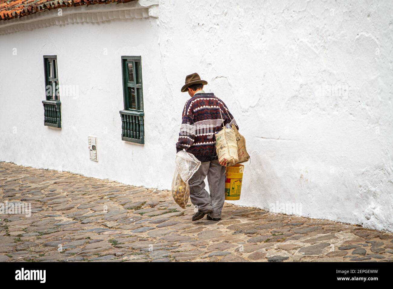Colombian native farmer,poncho,Ruana. with sacks vegetables.Villa de ...