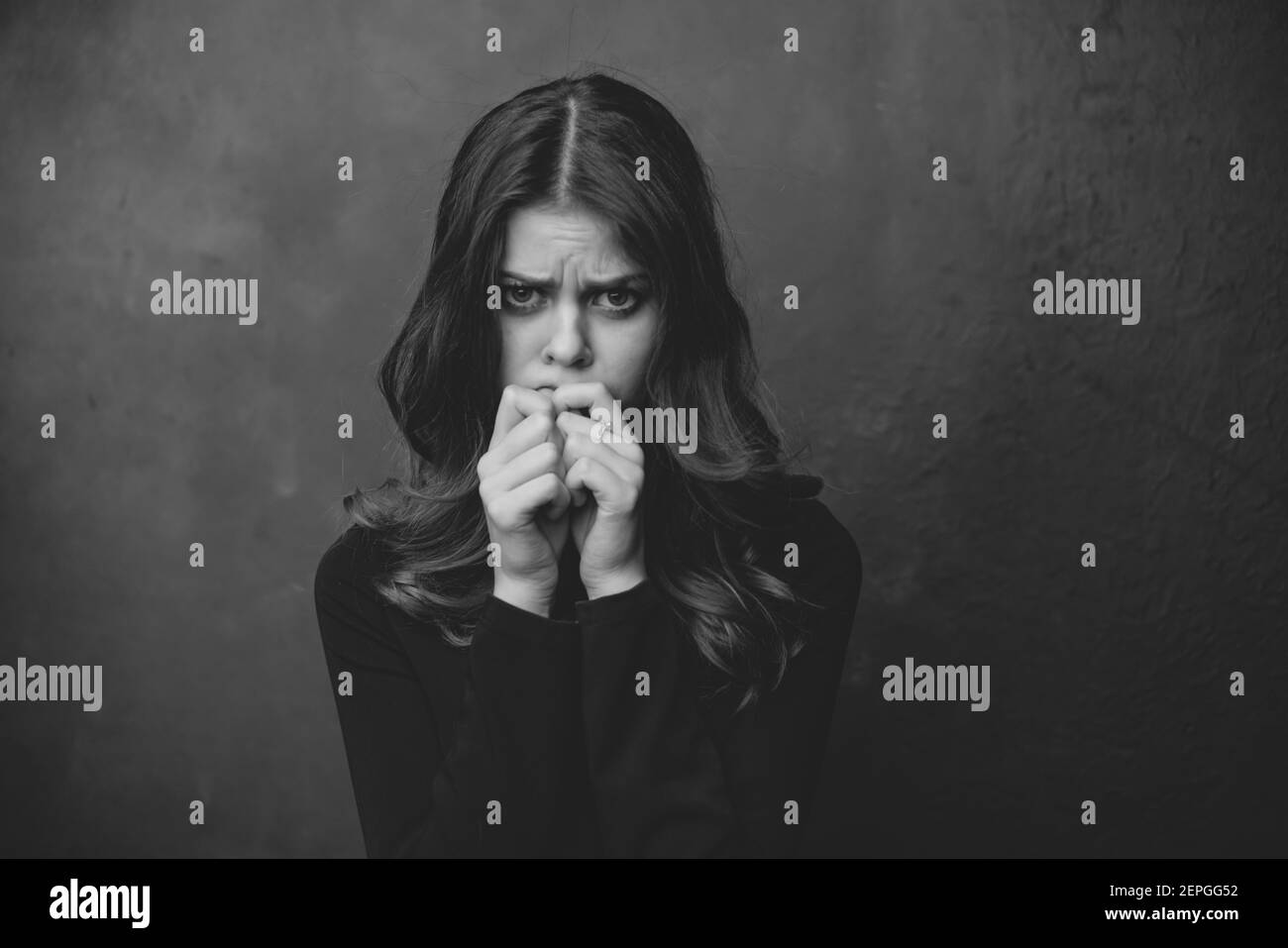 pretty woman emotions fear hands near face Stock Photo - Alamy