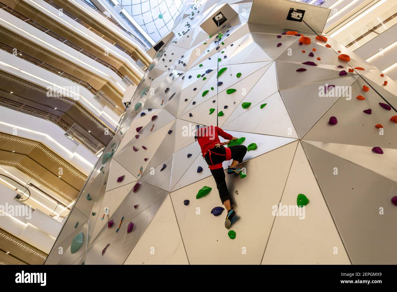 A young woman tries out the 55-meter-tall world's tallest indoor roket climbing wall at the New ...