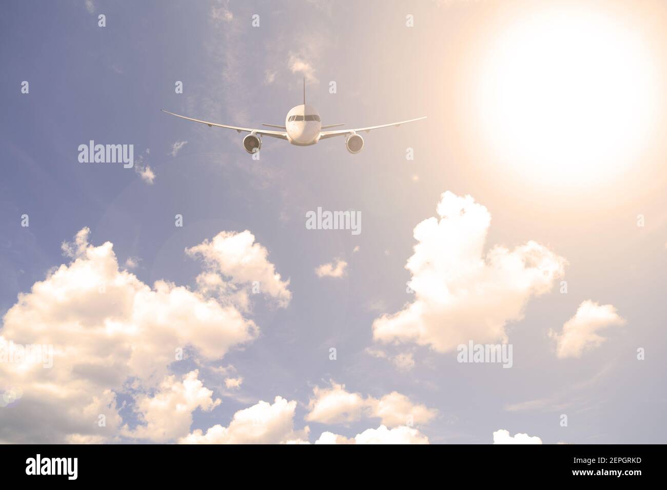 Airplane in the sky with clouds and the sun is shining. Sunset Stock ...