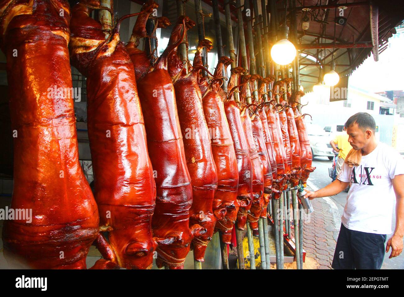 A workers arranges the lechon on display in Brgy, Salvation (Laloma ...