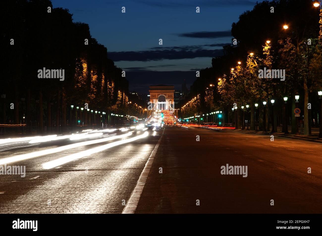 Champs-Elysees avenue at night with the Triumphal Arch in the ...